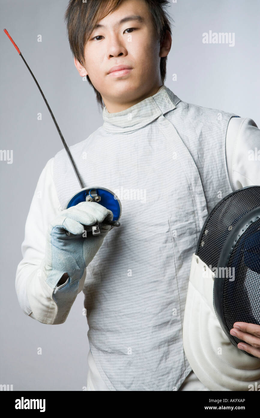 Portrait of a male fencer holding a sword and a fencing mask Stock ...