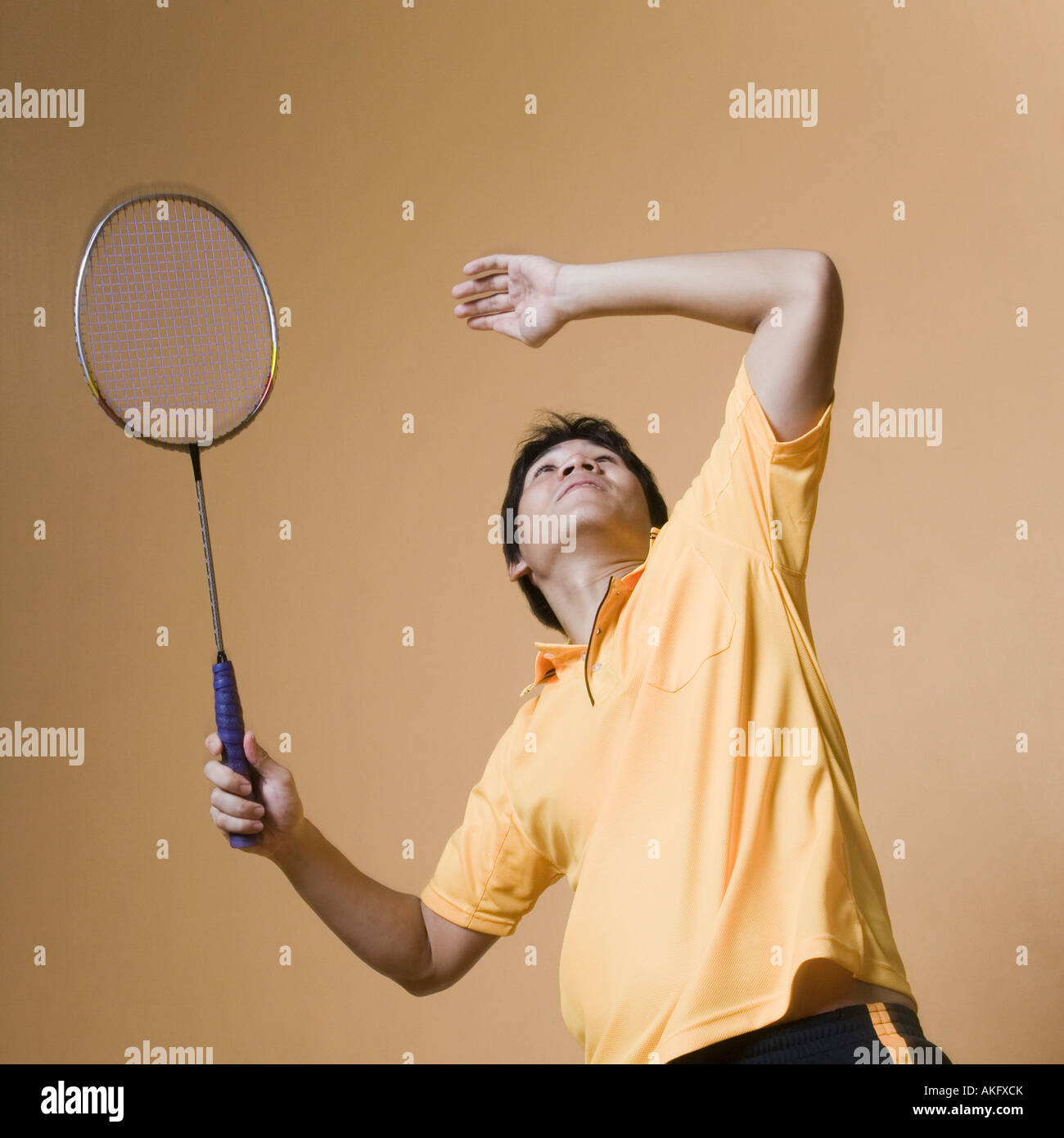 Young man playing badminton Stock Photo - Alamy