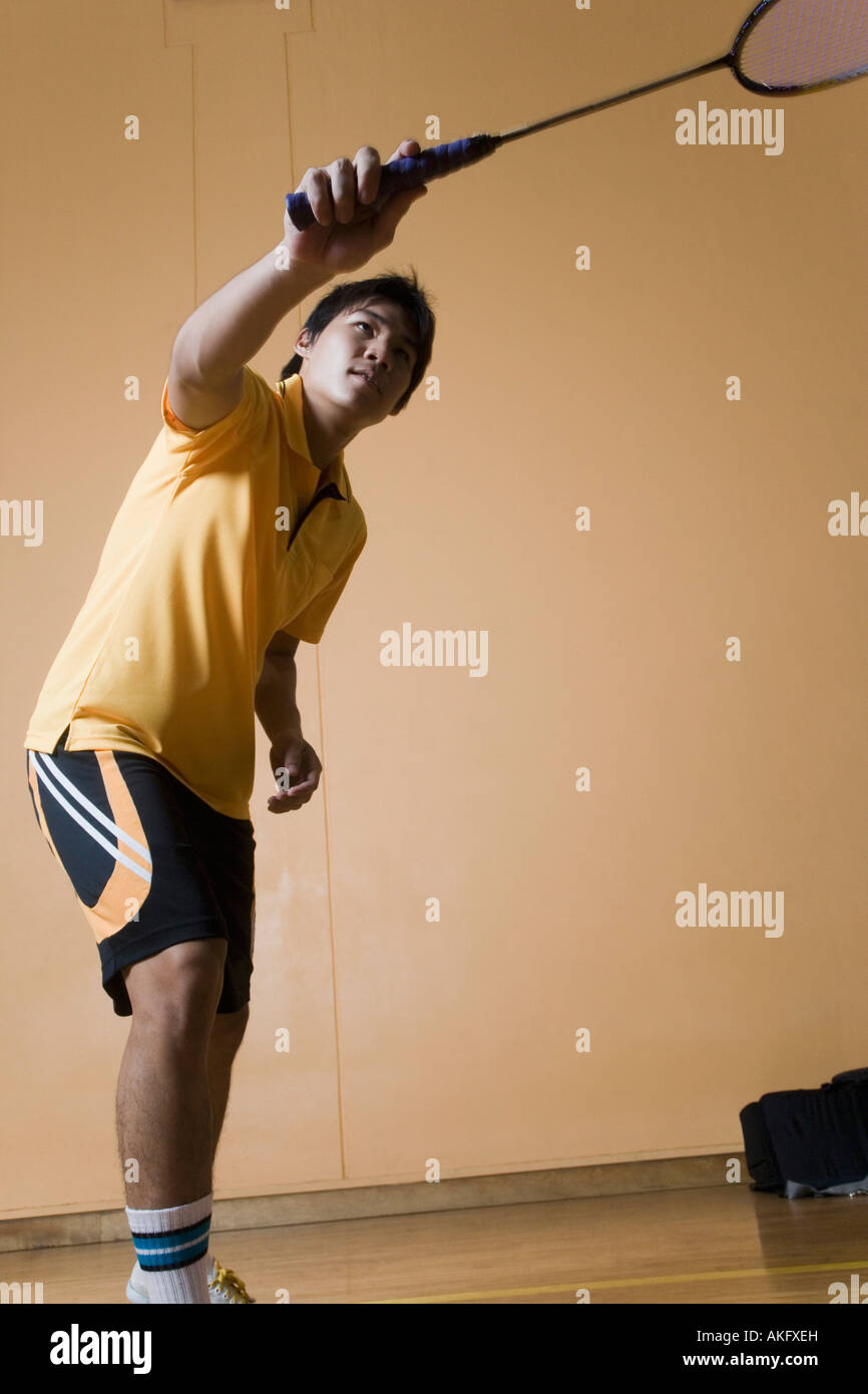 Young man playing badminton Stock Photo - Alamy