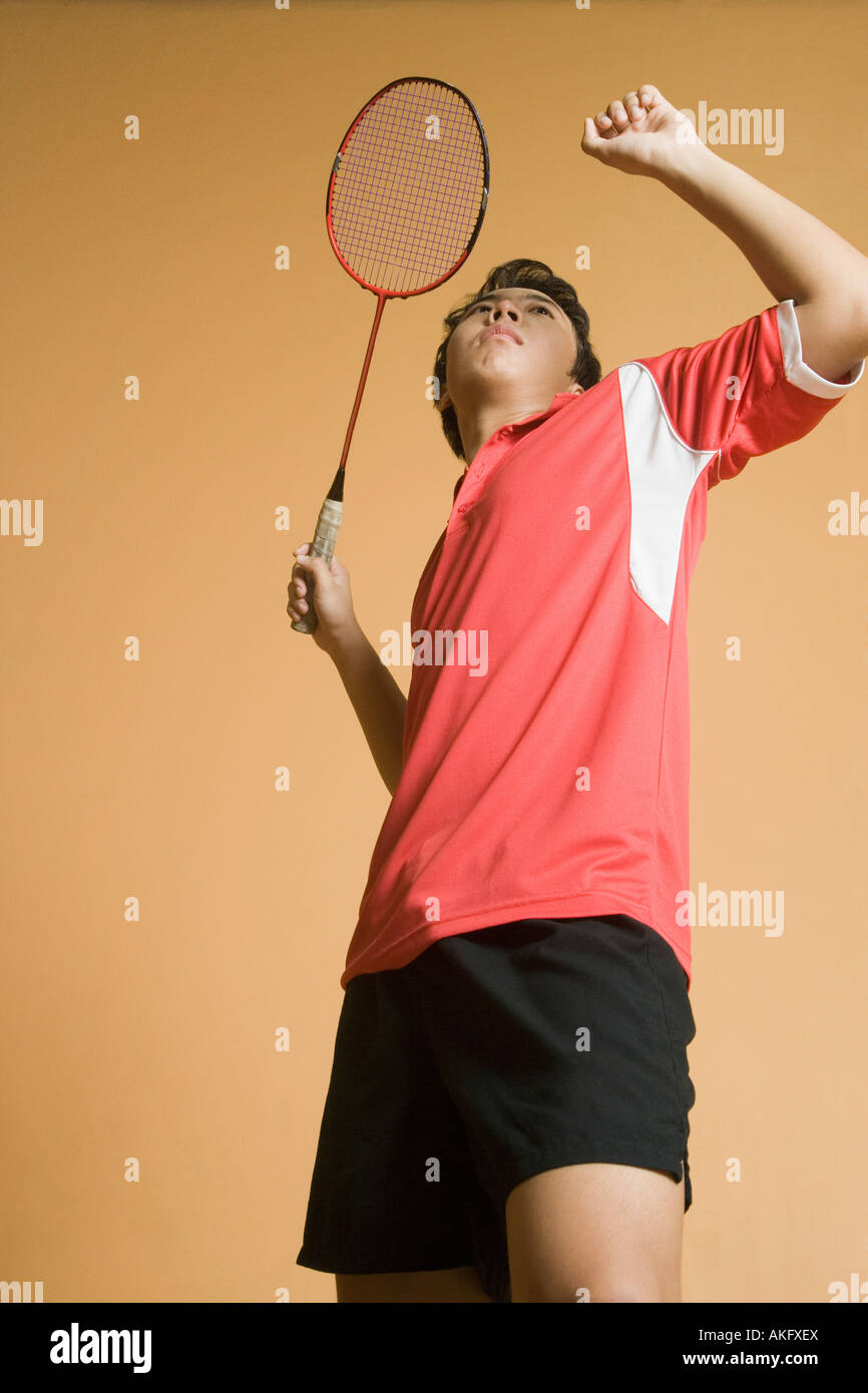Side profile of a young man playing badminton Stock Photo - Alamy