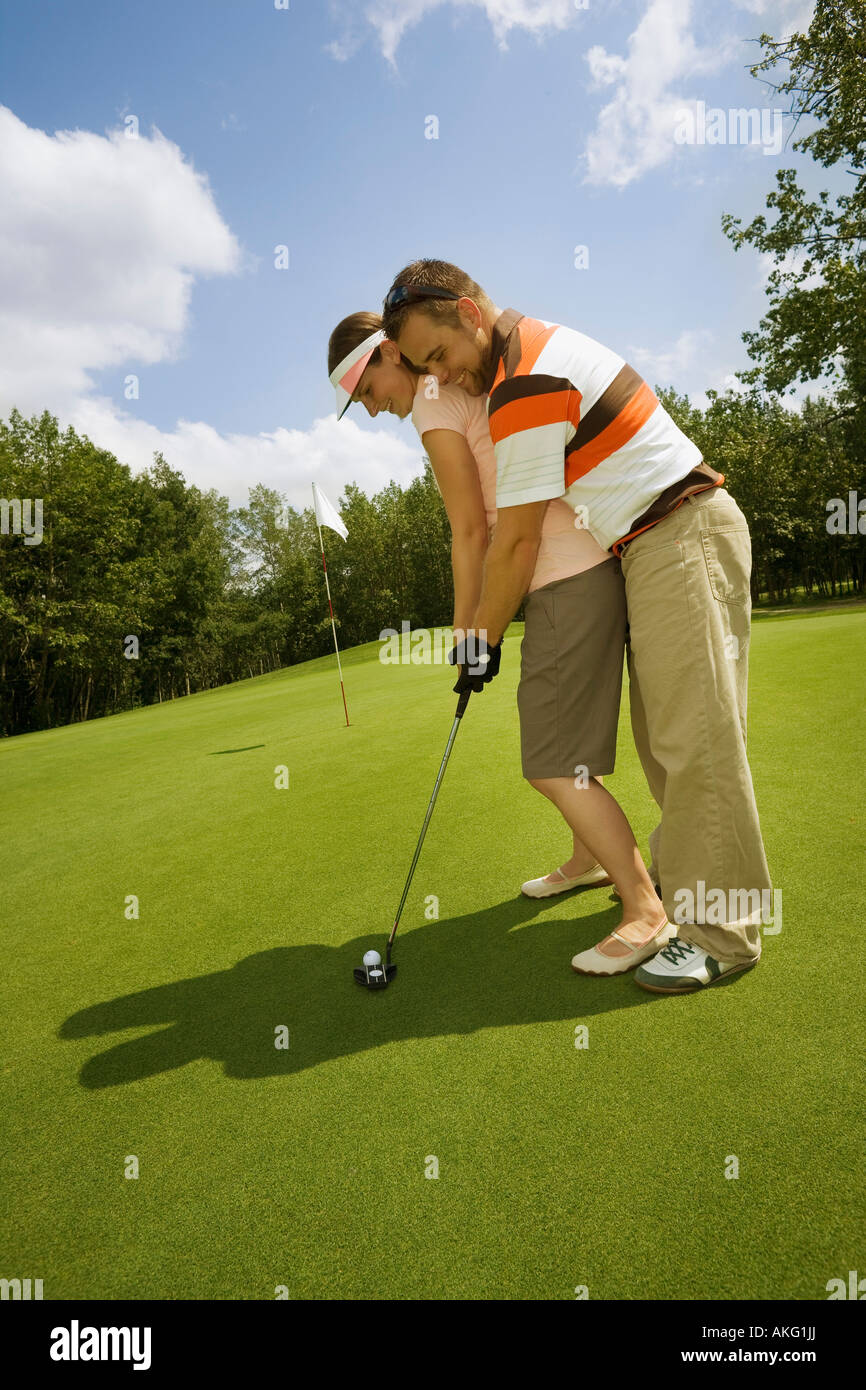 Couple playing golf Stock Photo - Alamy