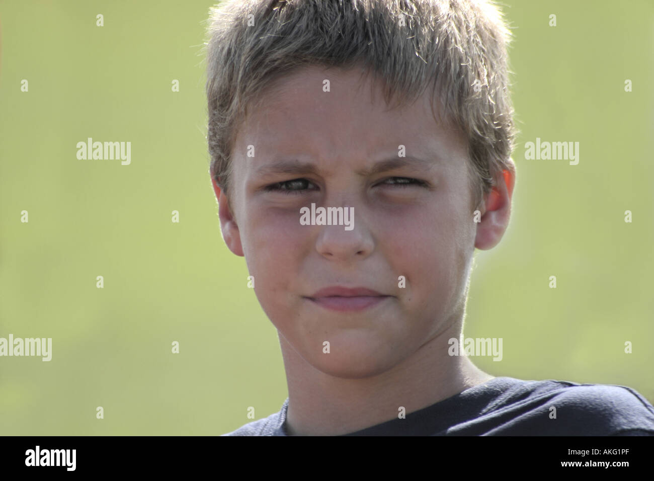 Young boy's face with an attitude Stock Photo - Alamy