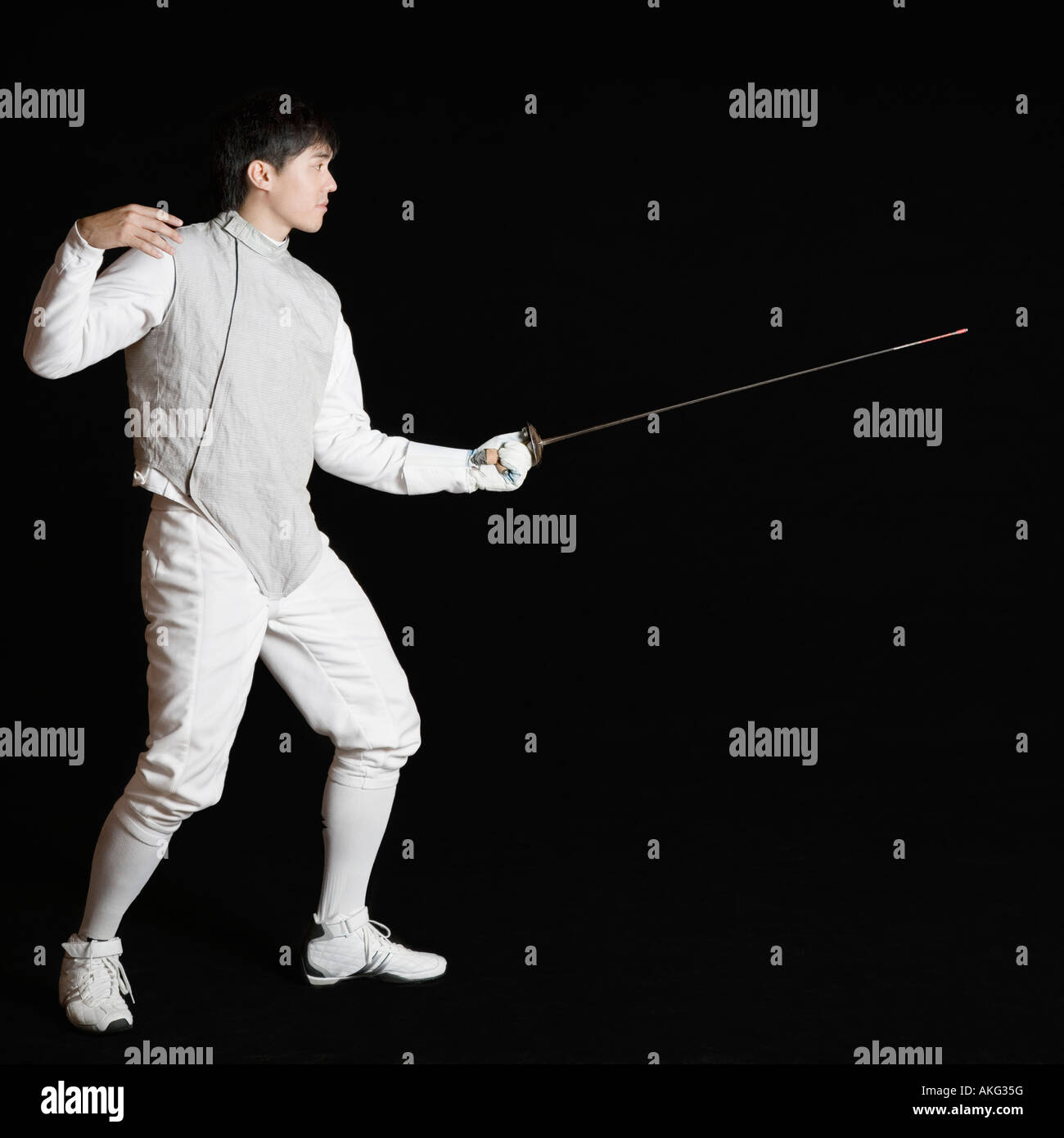 Male fencer holding a fencing foil Stock Photo - Alamy