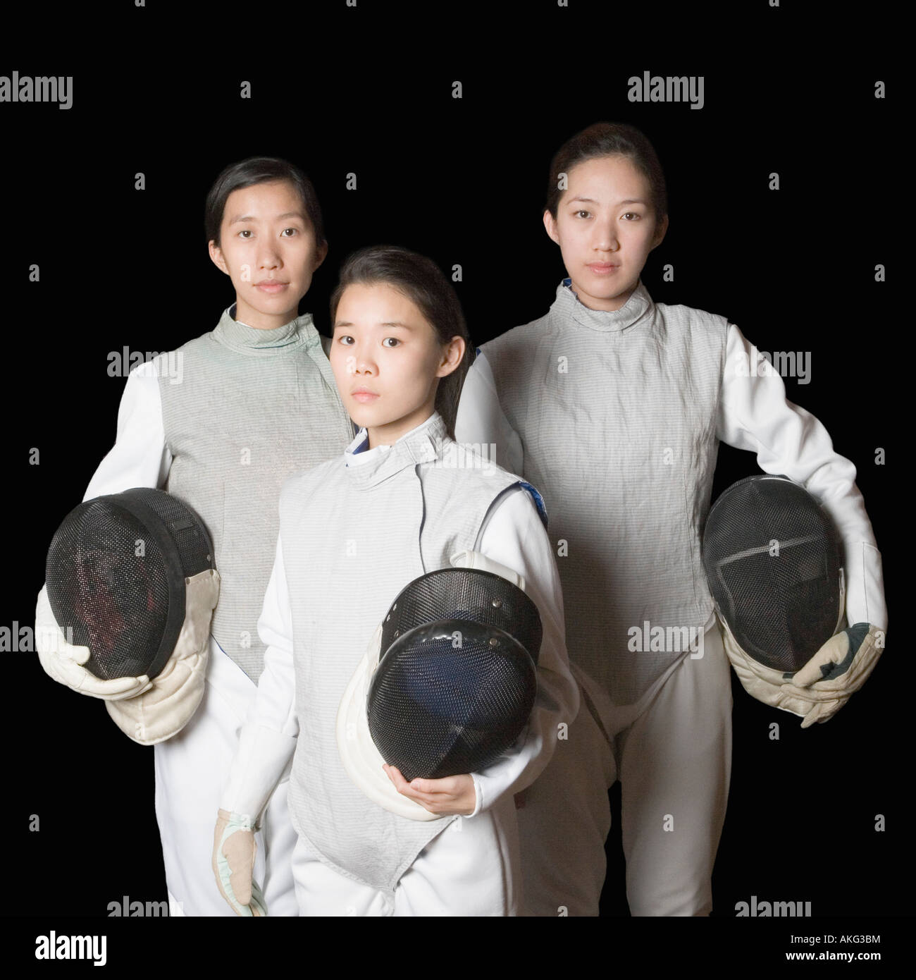 Portrait of three female fencers holding fencing masks Stock Photo - Alamy