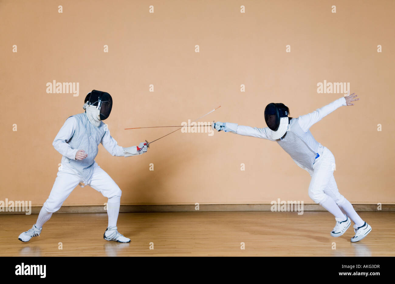 Two fencers fencing Stock Photo - Alamy