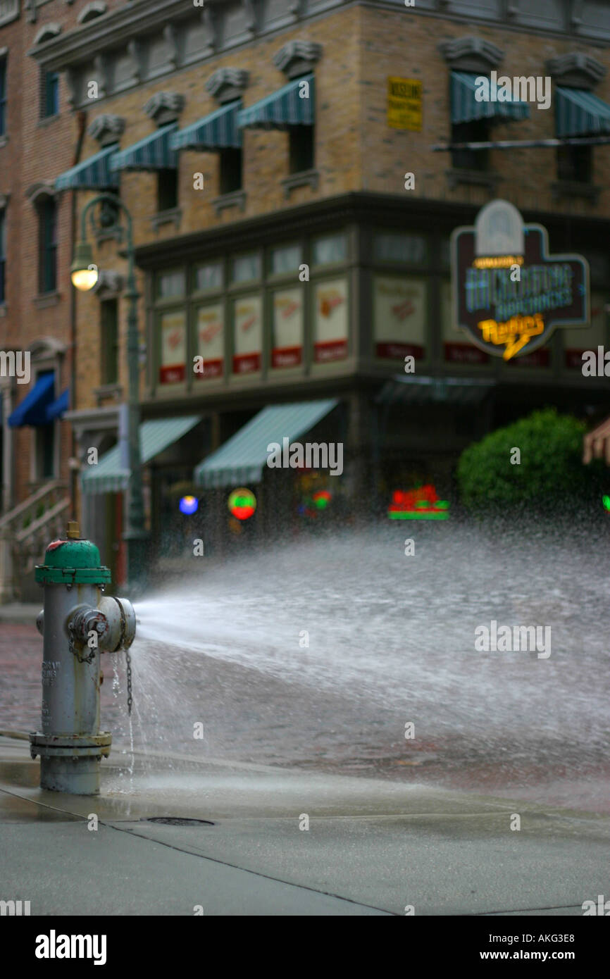 Fire hydrant spraying water american street scene Stock Photo - Alamy