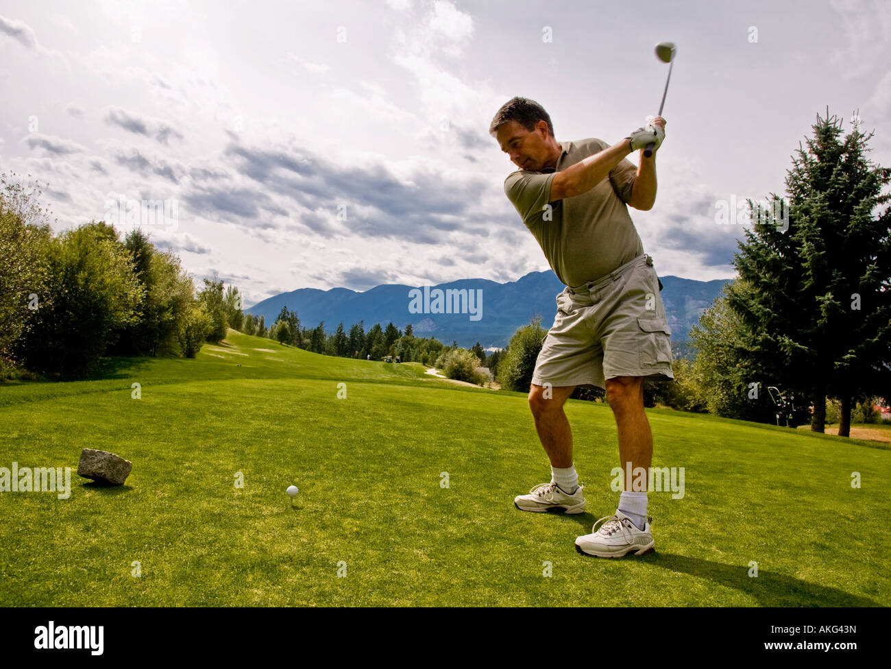 Golfer taking his first shot Stock Photo - Alamy