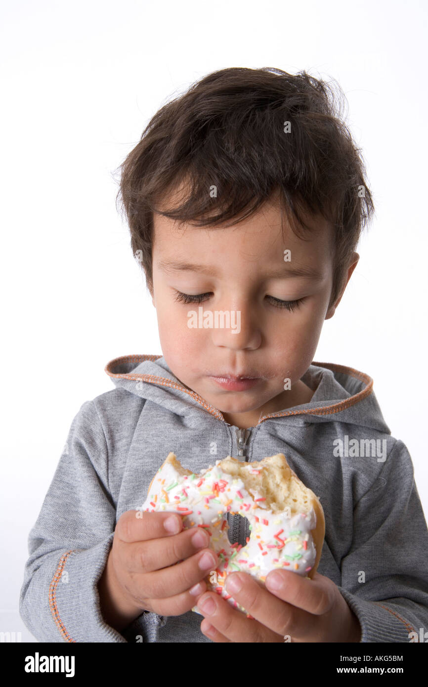Little boy eating a donut Stock Photo - Alamy