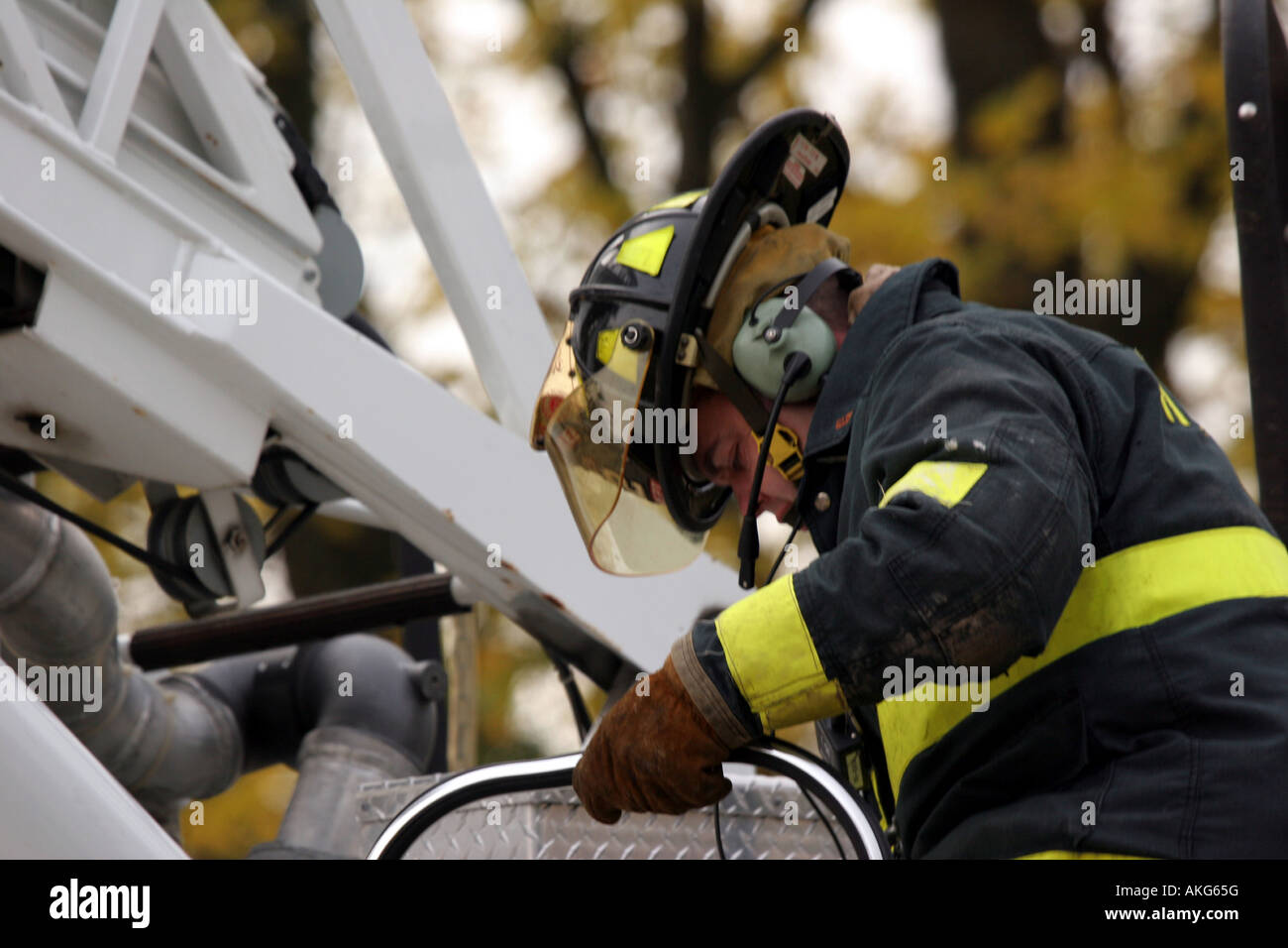 Fireman climbing a ladder hi-res stock photography and images - Alamy