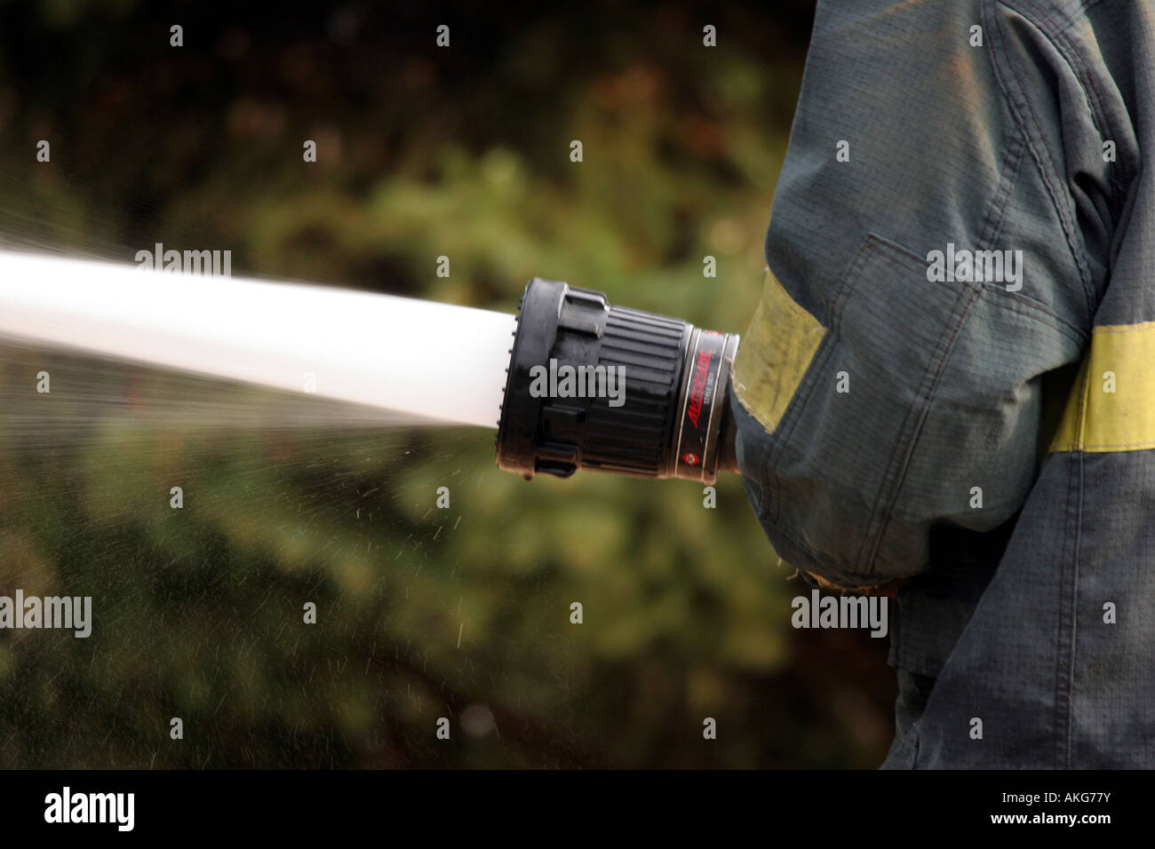 Fireman holding water hose hi-res stock photography and images - Alamy