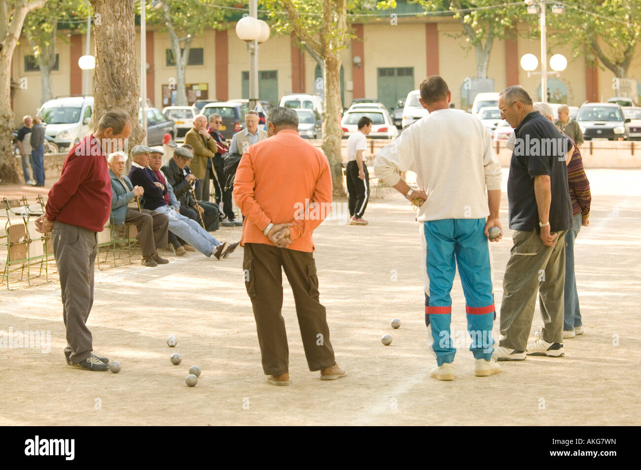 Frenchmen playing boules in village square Stock Photo - Alamy