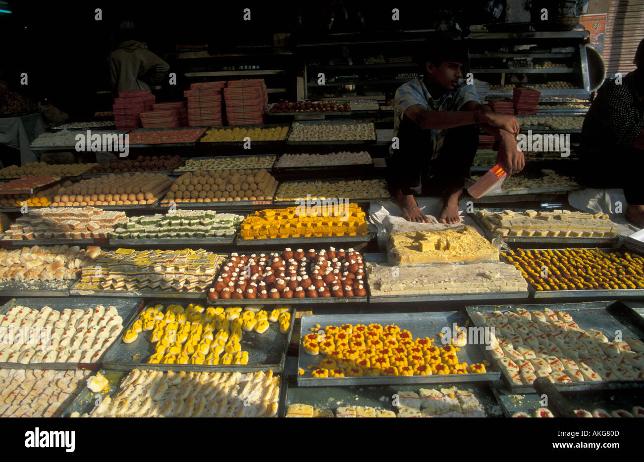Man selling Indian sweets by the road in India Stock Photo - Alamy