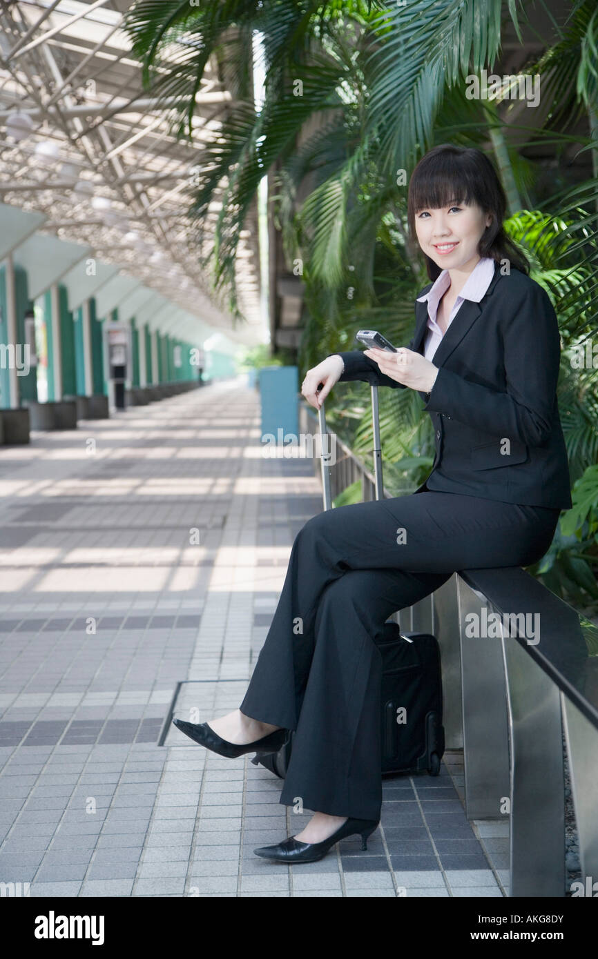 Side profile of a woman sitting on a railing hi-res stock photography ...