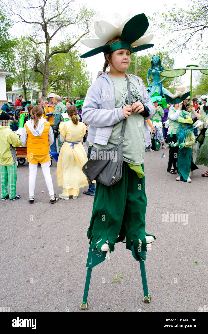 Girl age 10 part of the flowers on stilts unit waiting for parade start ...