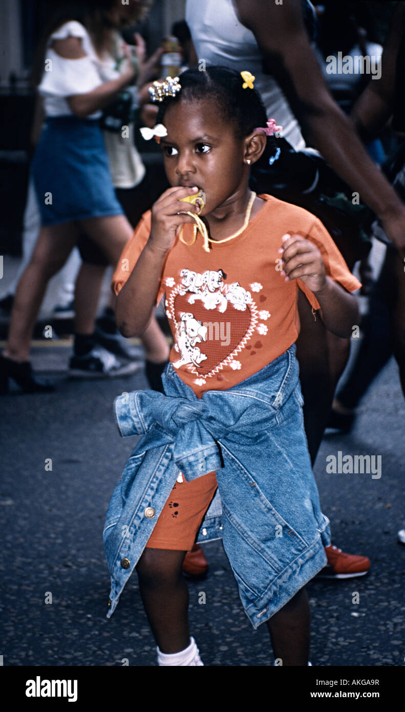 nottinghill carnival a young girl blowing a whistle whilst running in ...