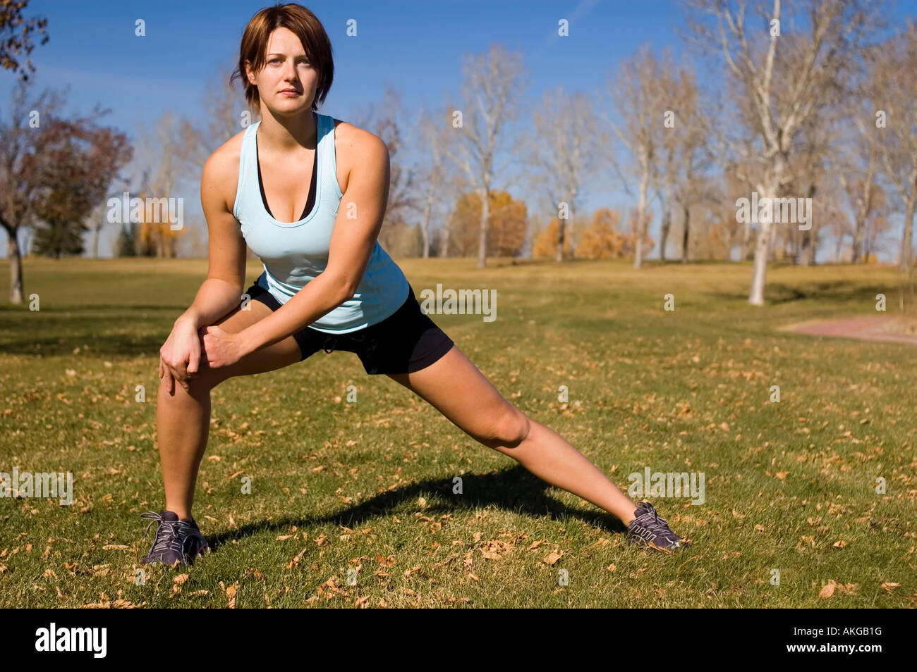 Young woman stretching groin Stock Photo - Alamy