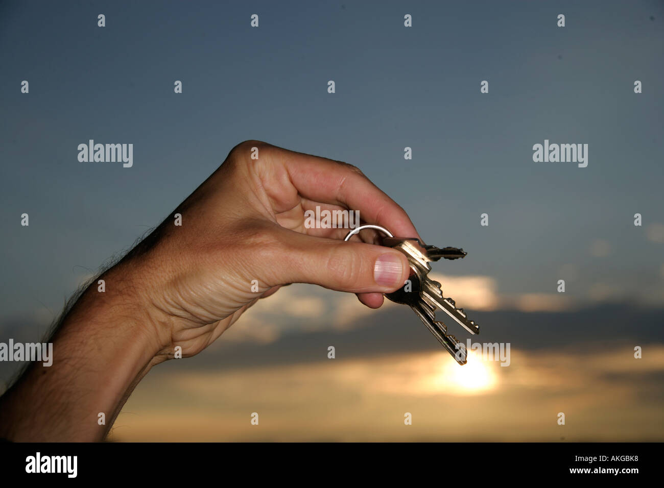 Hand holding keys Stock Photo - Alamy