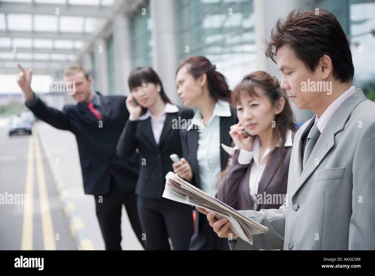 Business executives hailing a taxi at an airport Stock Photo - Alamy