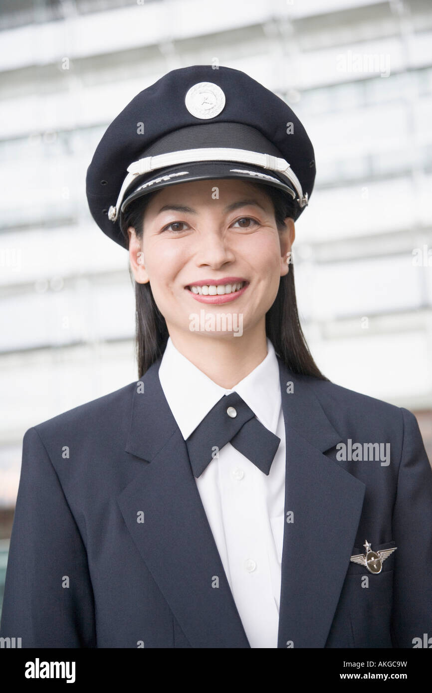 Portrait of a female pilot smiling Stock Photo - Alamy