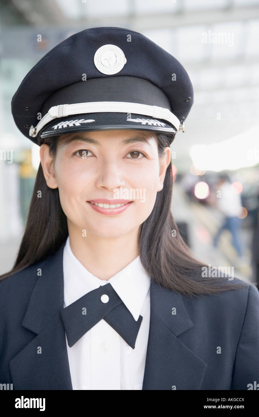 Portrait of a female pilot smiling Stock Photo - Alamy