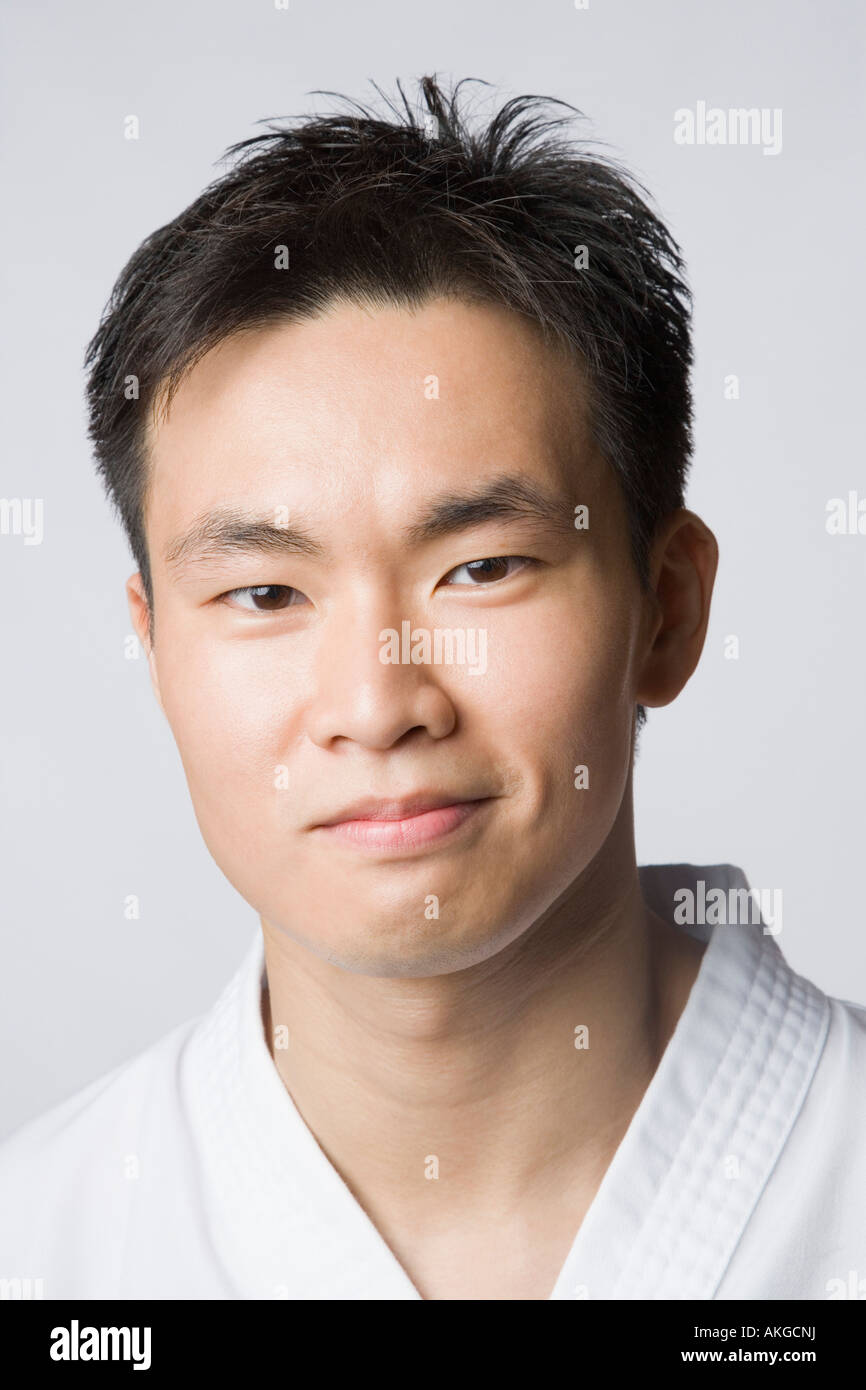 Portrait of a young man smirking Stock Photo - Alamy