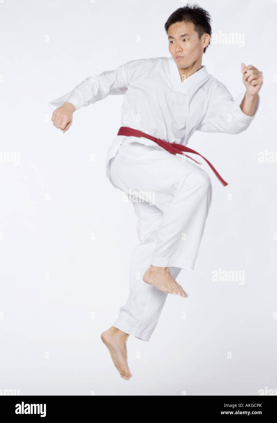 Young man in kicking position Stock Photo - Alamy