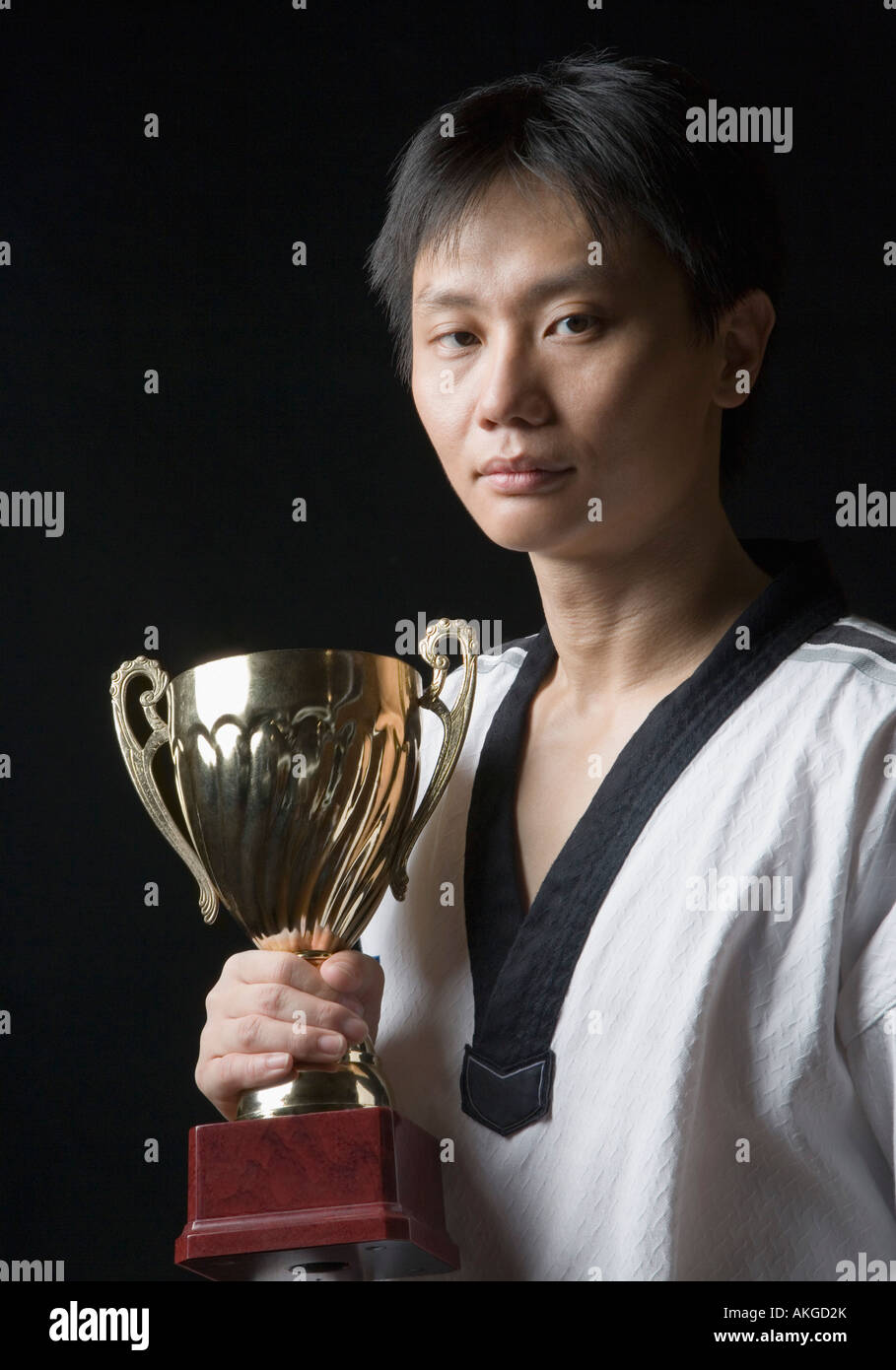 Portrait of a young man holding a trophy Stock Photo - Alamy