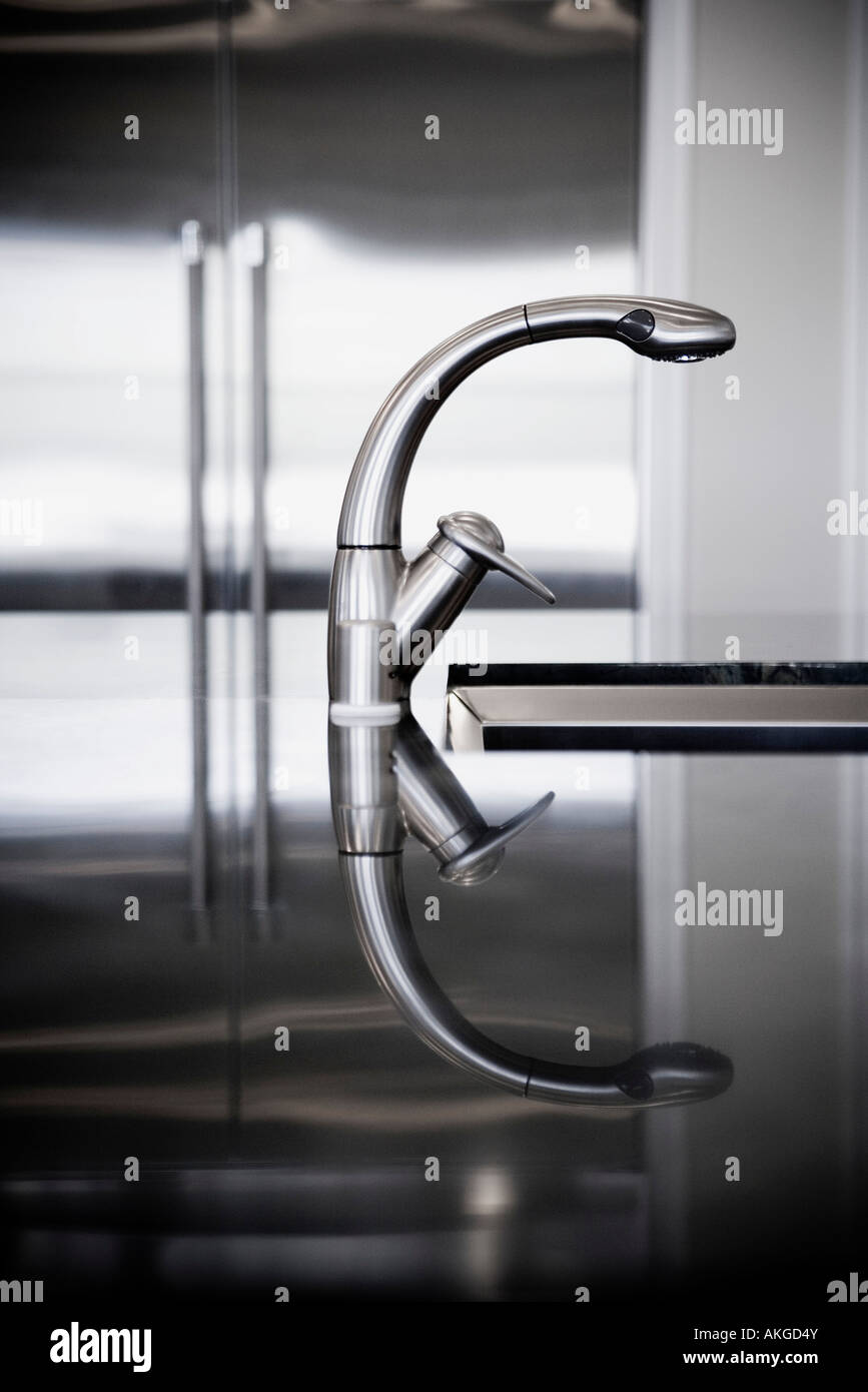 Detail of stainless steel faucet with reflection Stock Photo - Alamy