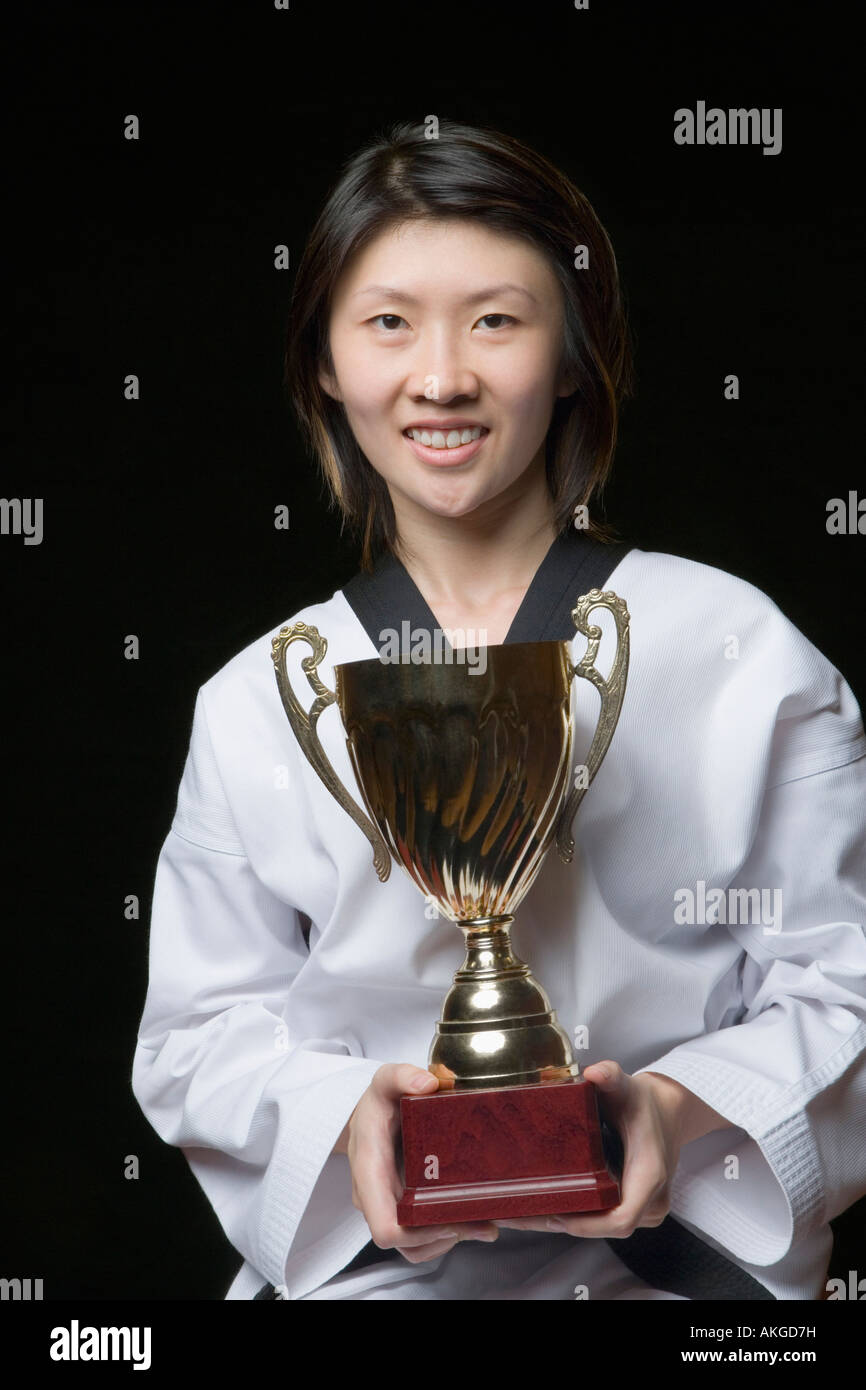 Portrait of a young woman holding a trophy Stock Photo - Alamy