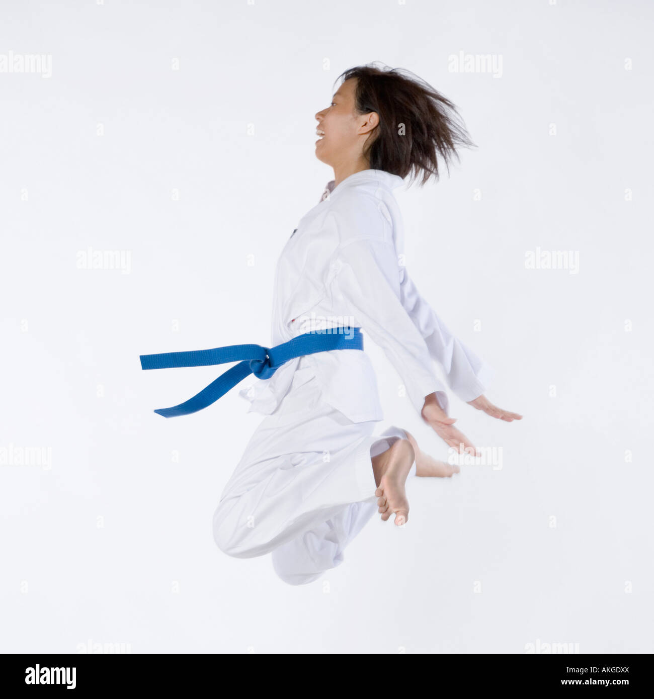 Side profile of a young woman jumping and practicing martial arts Stock ...