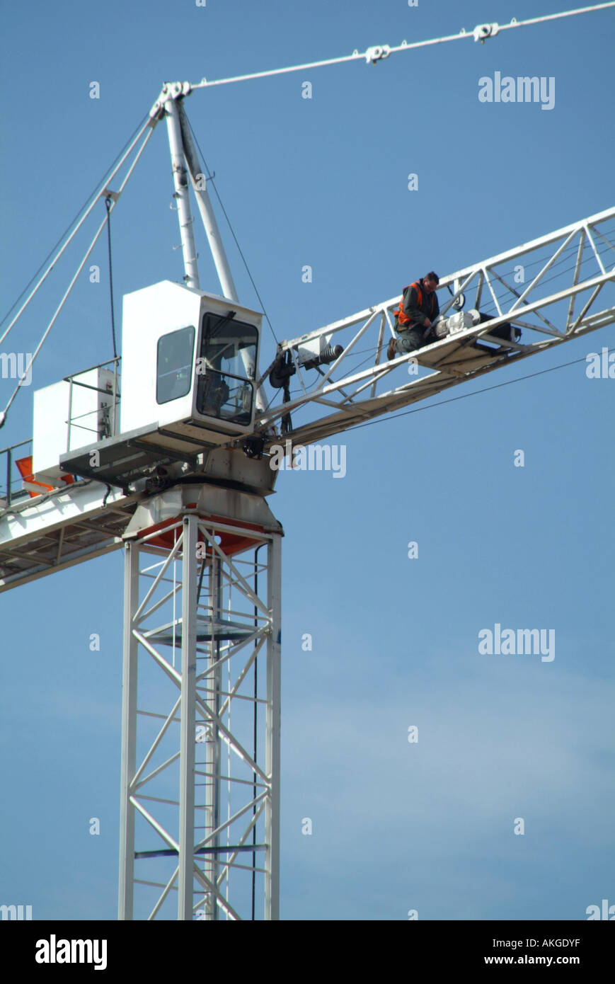Man standing on the jib arm of a crane high above the ground Stock ...