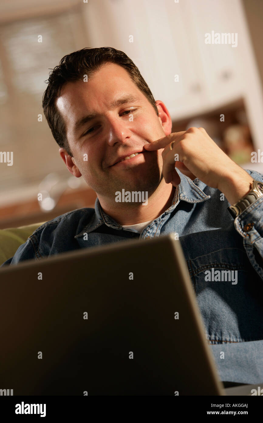 Man sitting with laptop computer Stock Photo - Alamy