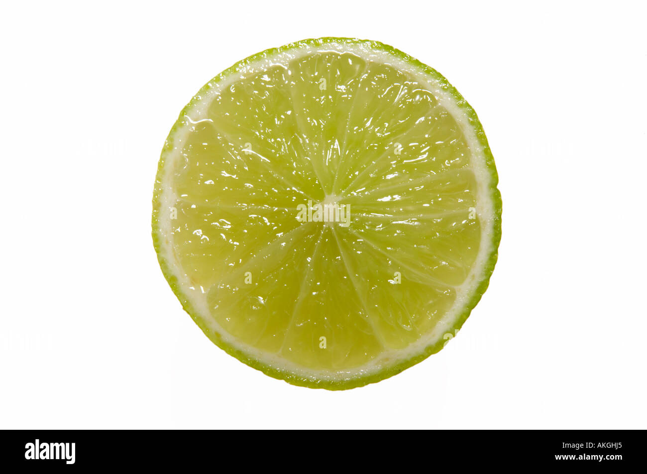 CLOSE UP VIEW OF SLICE THROUGH FRESH LIME ON WHITE BACKGROUND Stock ...