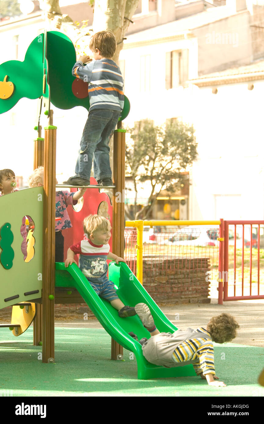 toddlers play on a slide in a playground Stock Photo - Alamy