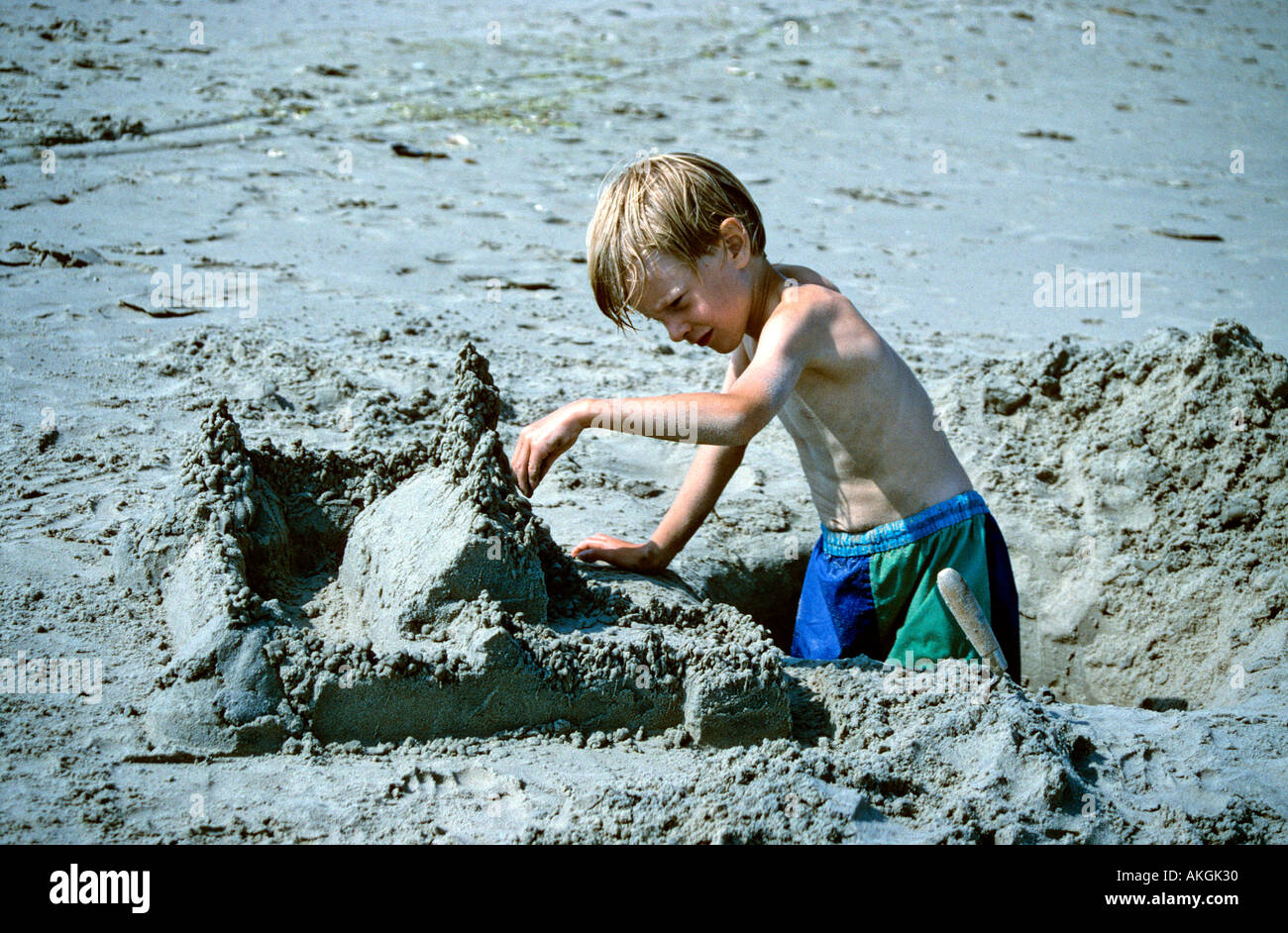Boy building a sand castle Stock Photo - Alamy
