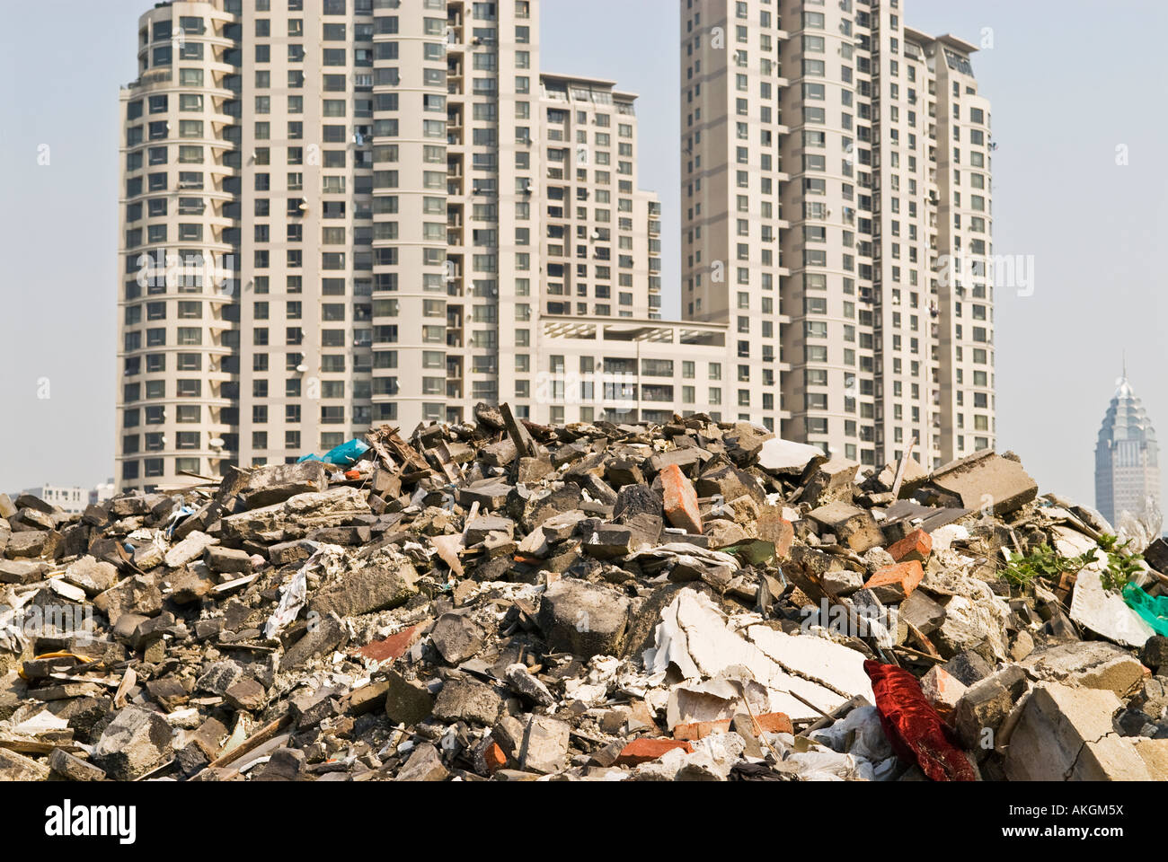 Rubble of demolished building with modern apartment buildings in ...