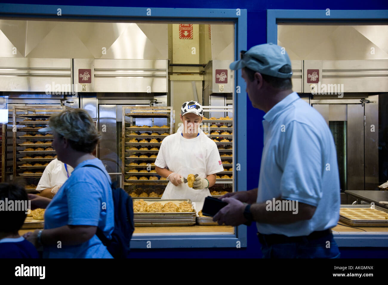 WISCONSIN Milwaukee Workers making cream puffs viewed through glass ...
