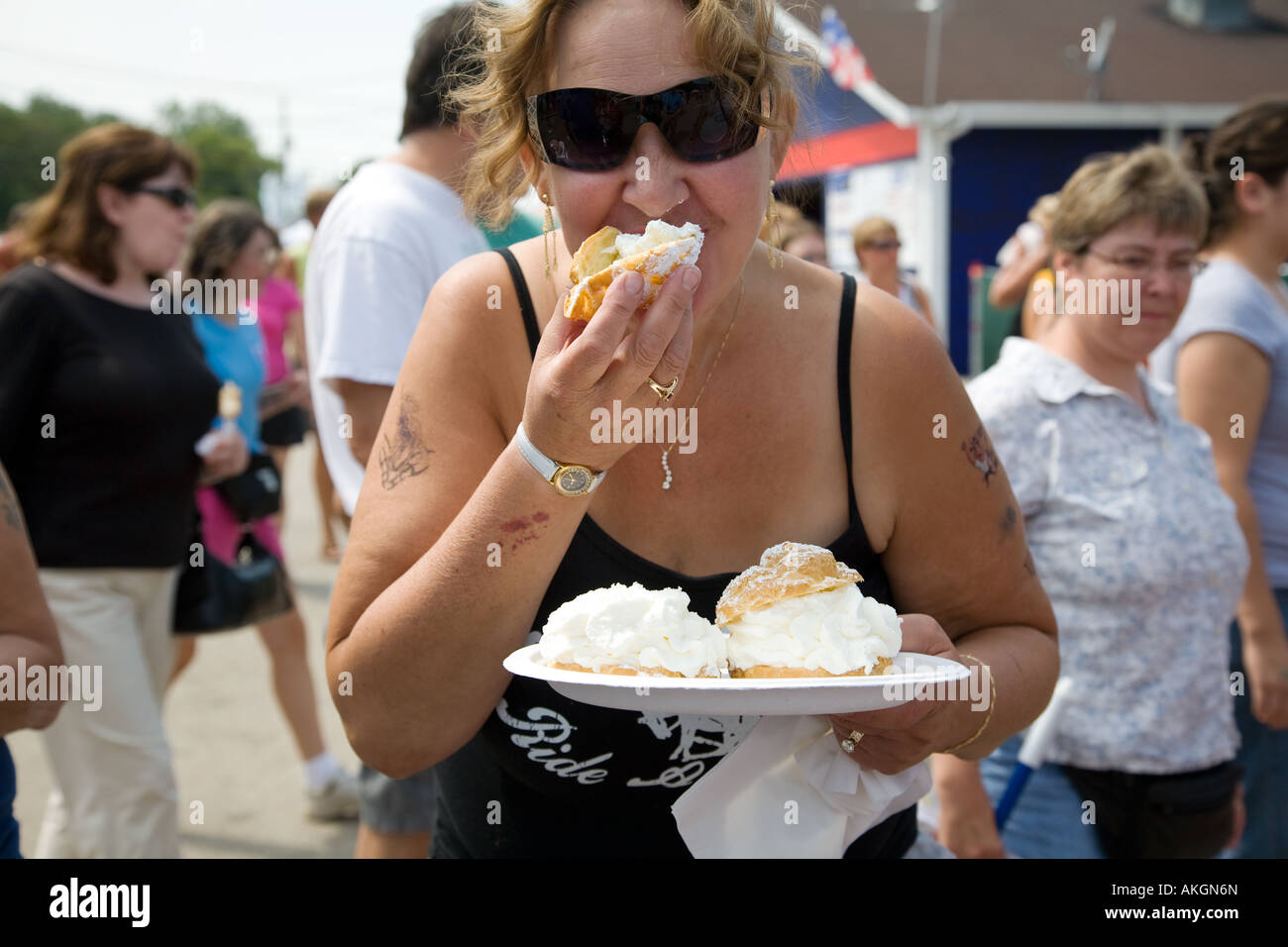 WISCONSIN Milwaukee Woman eat half of cream puff two pastries on plate ...