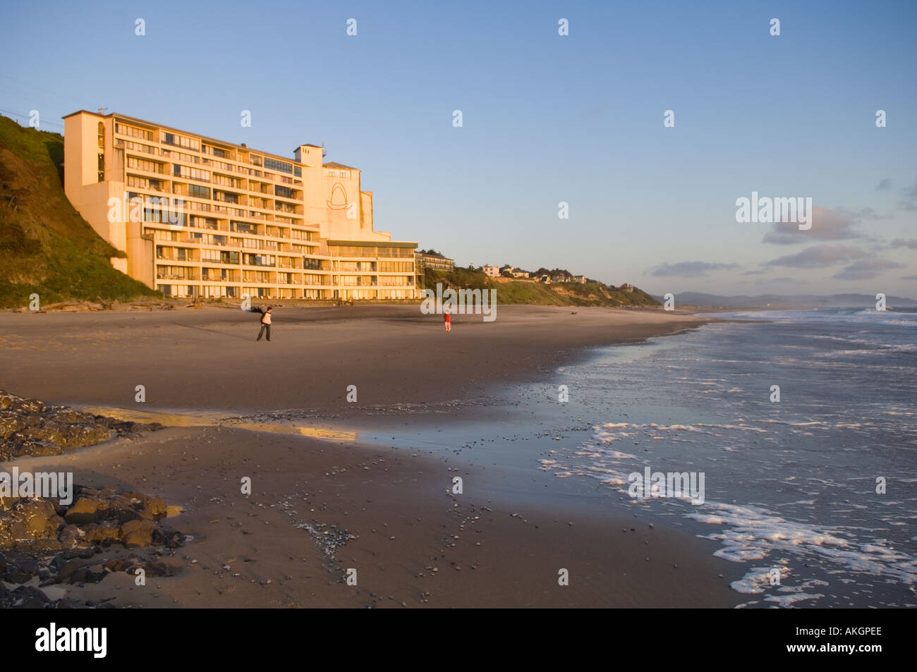 The Inn at Spanish Head resort hotel with couple on the beach at sunset ...
