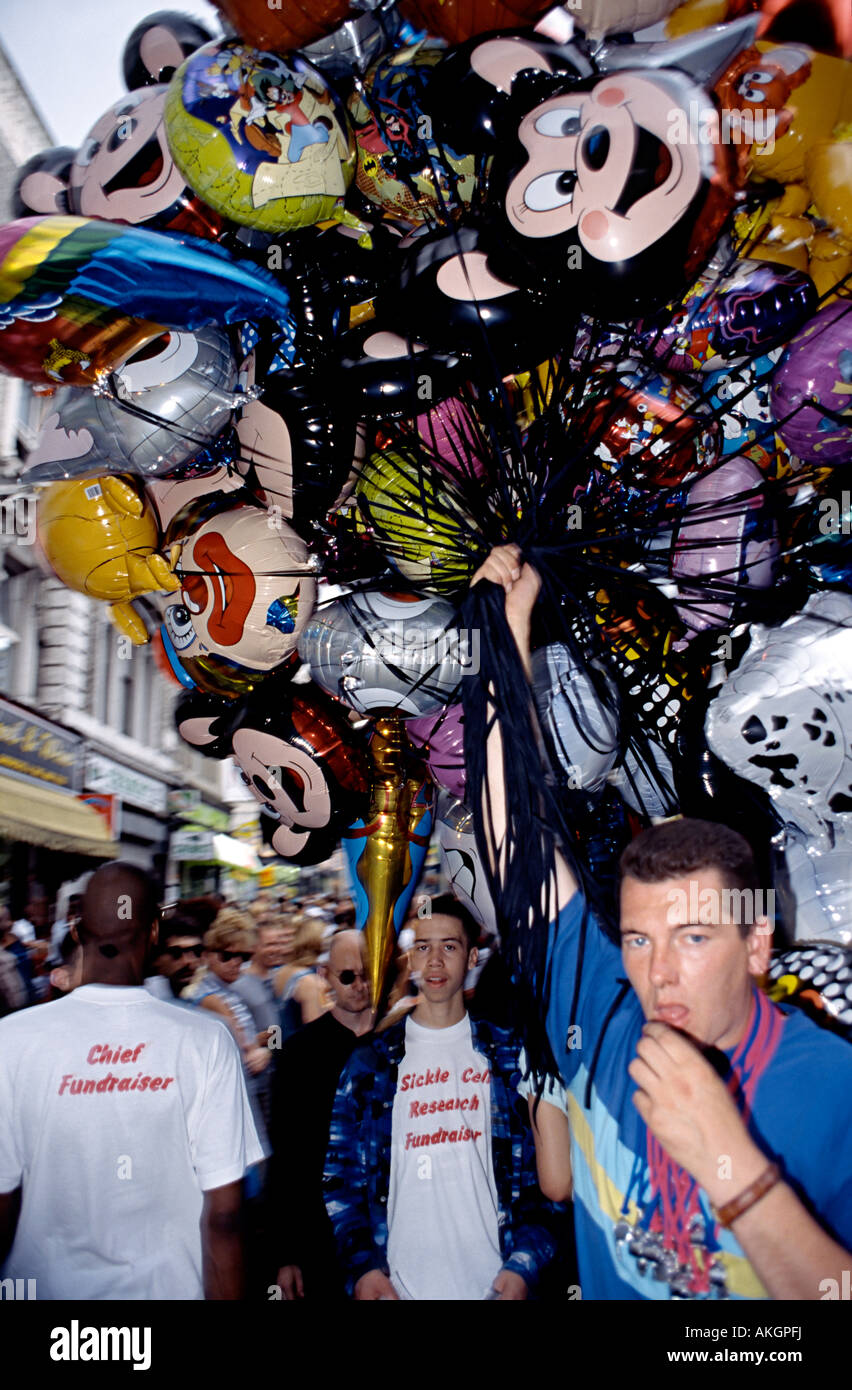 nottinghill carnival a balloon seller selling balloons in the crowd in ...