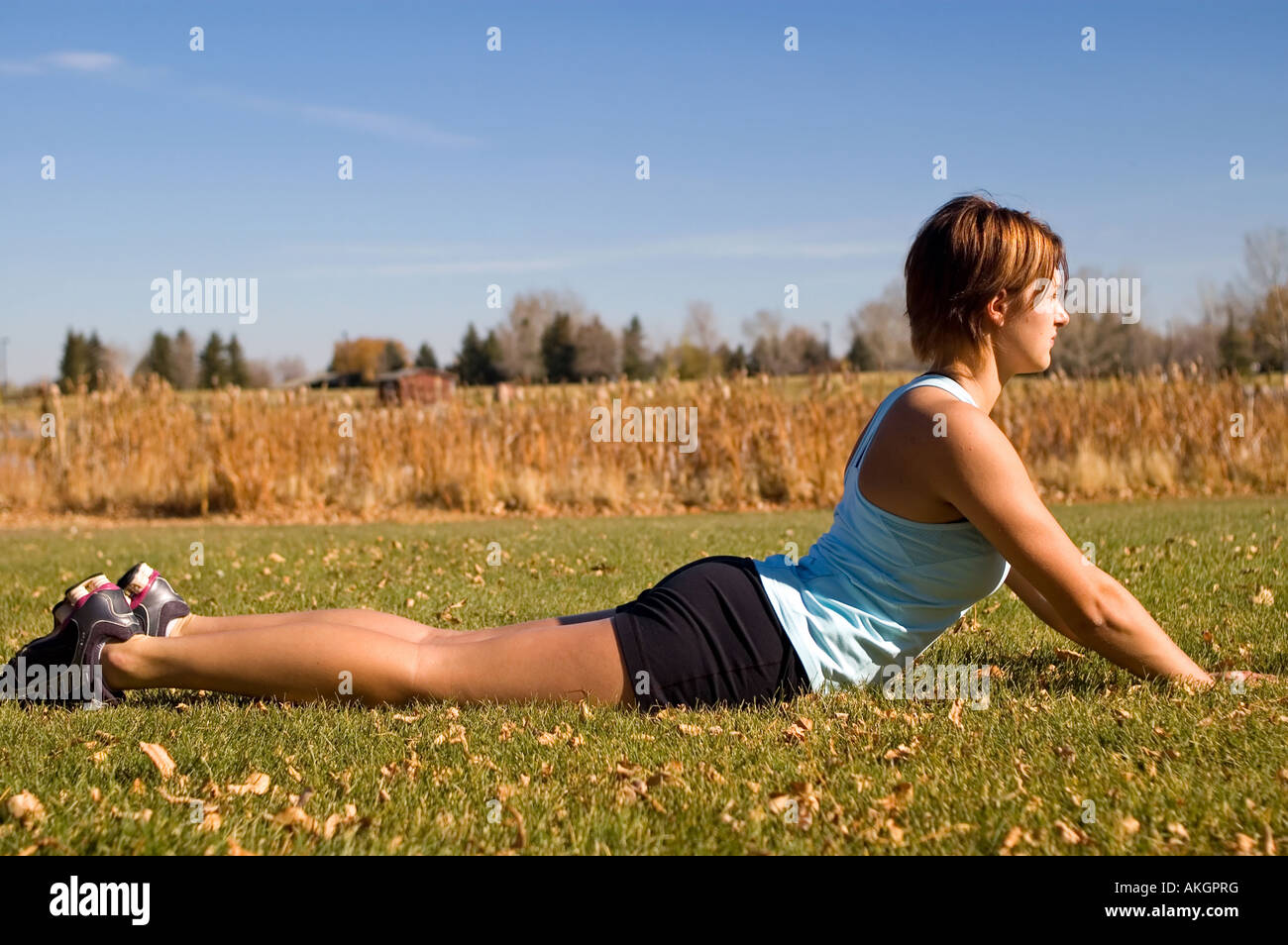 Young woman doing a stomach stretch Stock Photo - Alamy