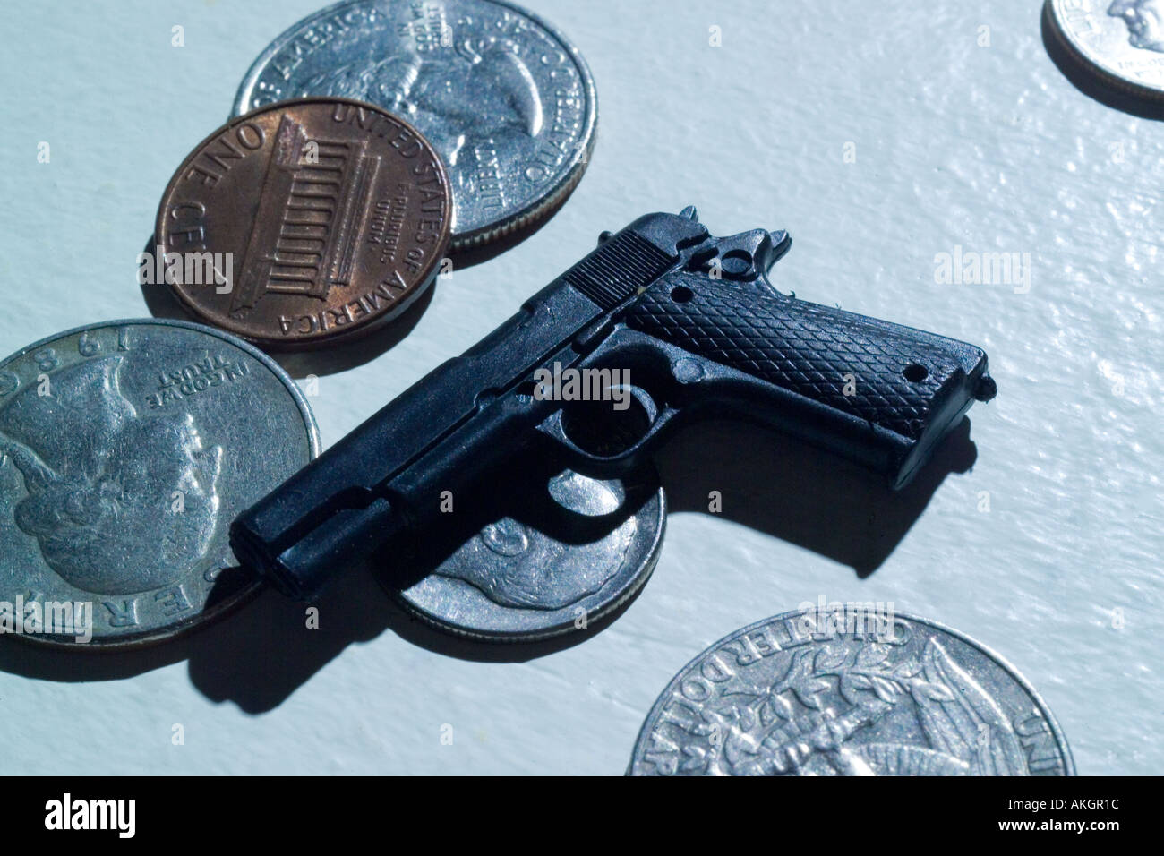 toy gun with coins Stock Photo - Alamy