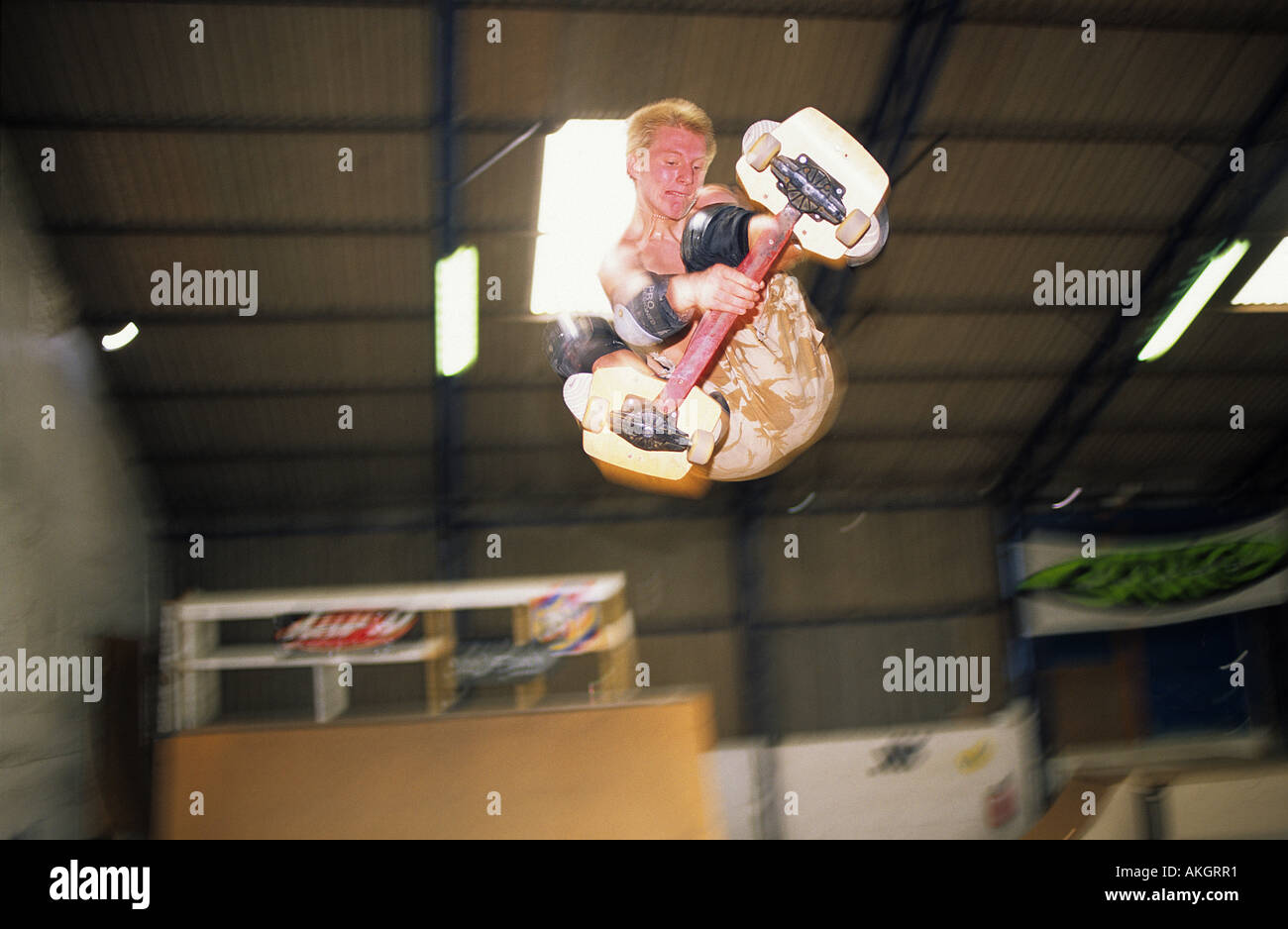 Snakeboarder in mid jump Stock Photo - Alamy