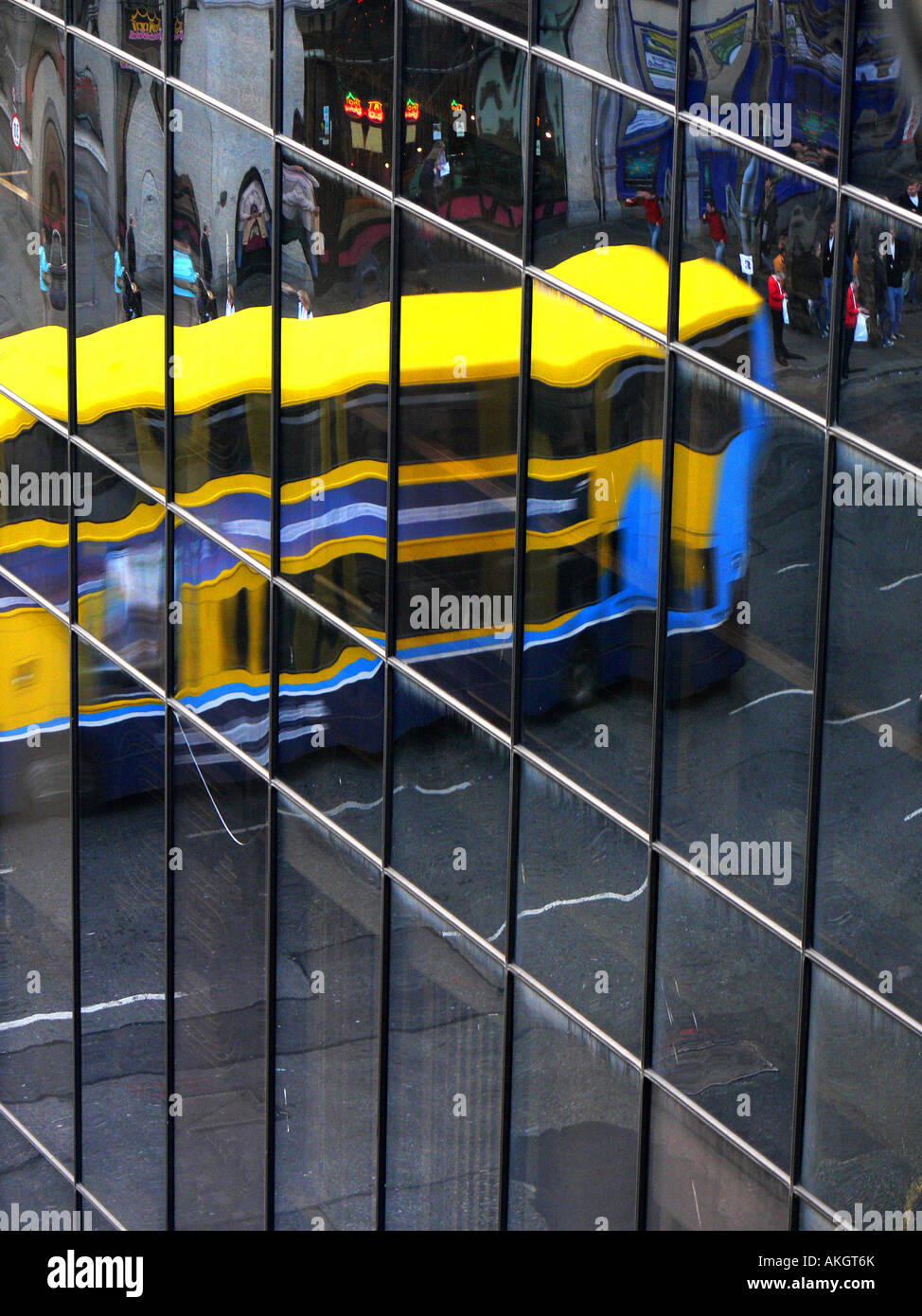 DUBLIN BUS REFLECTION IN THE GLASS FACADE OF A BUILDING IN THE CITY ...