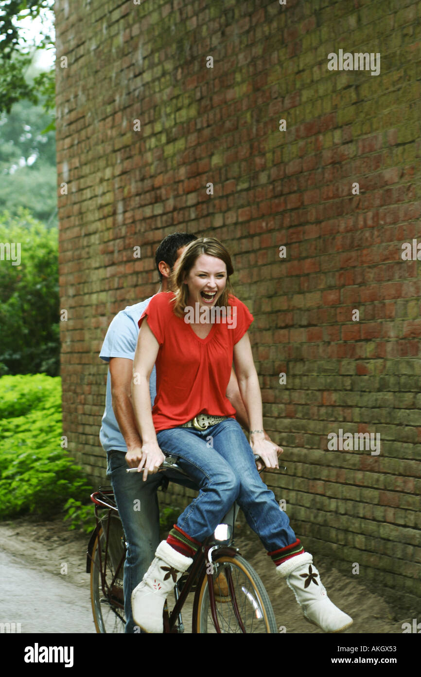 Woman getting a lift on bicycle Stock Photo - Alamy