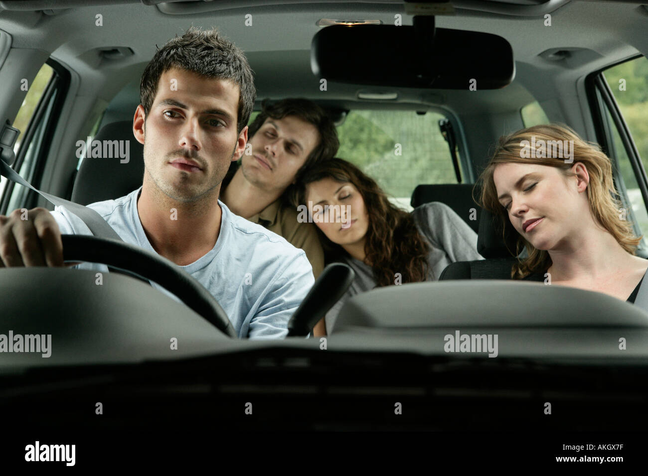 Man driving car with 3 passengers who are asleep Stock Photo - Alamy