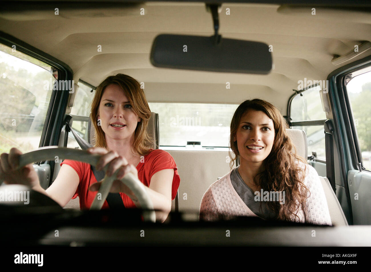 Woman driving car with female passenger Stock Photo - Alamy
