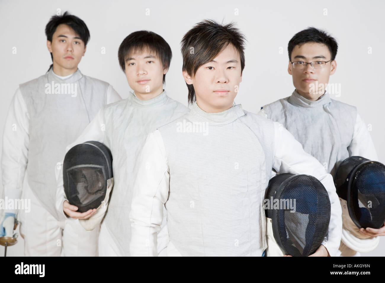 Portrait of four male fencers standing Stock Photo - Alamy
