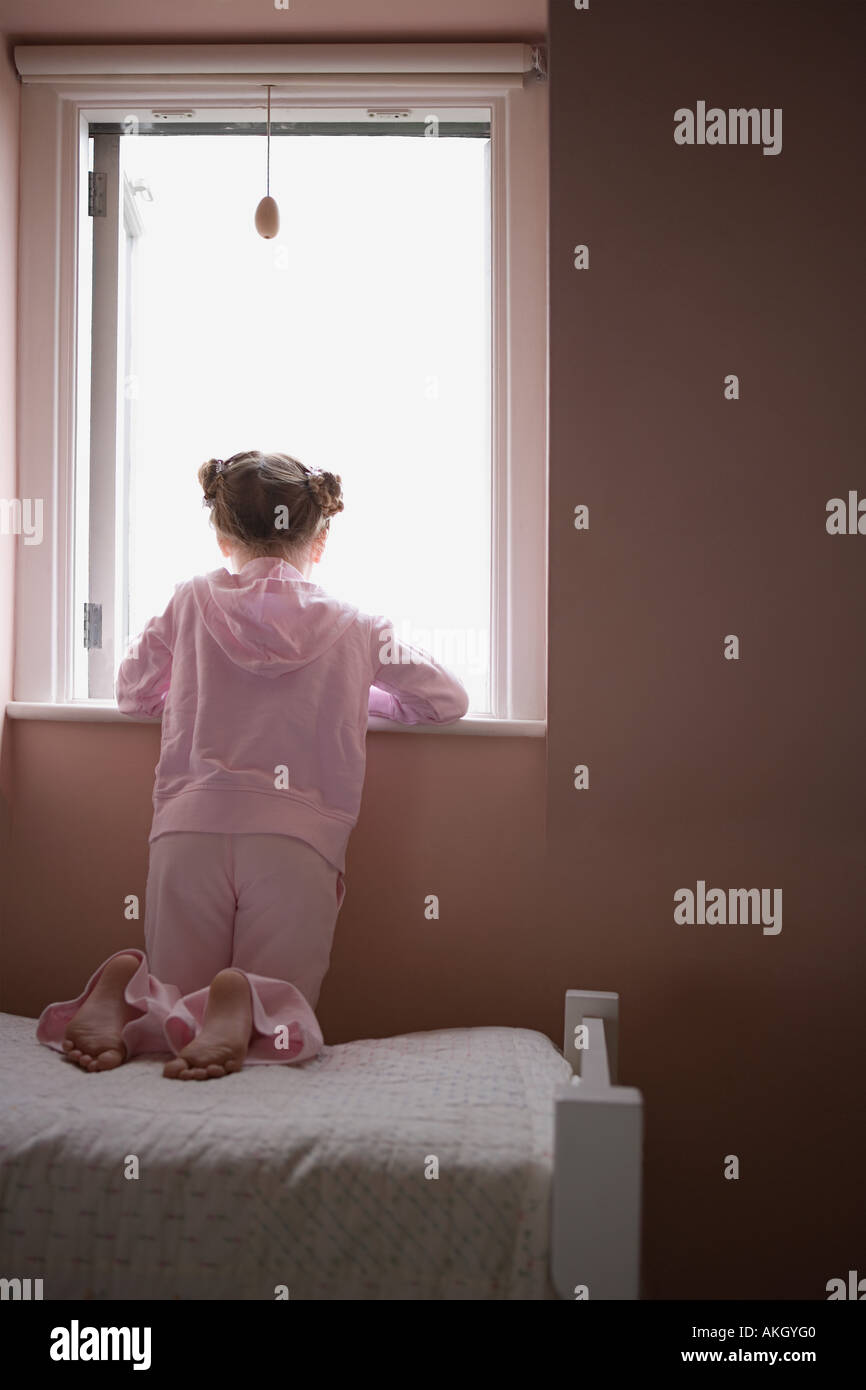 Girl looking out of window Stock Photo - Alamy