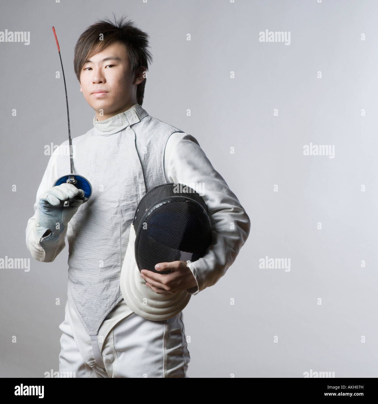 Portrait of a male fencer holding a sword and a fencing mask Stock ...